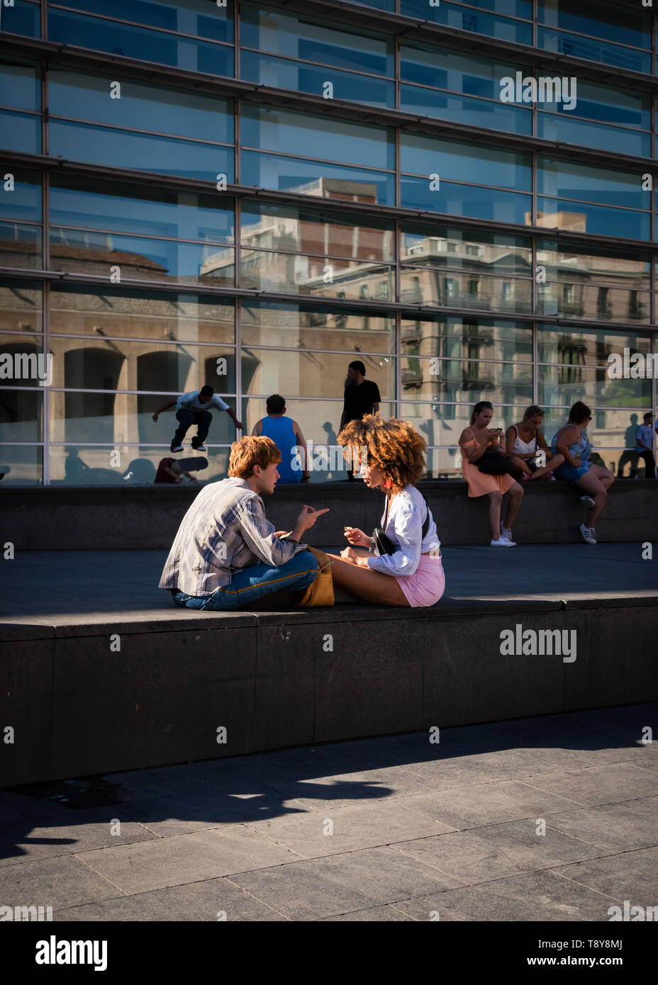 Two young tourists sitting on beautiful square in Barcelona Raval ...