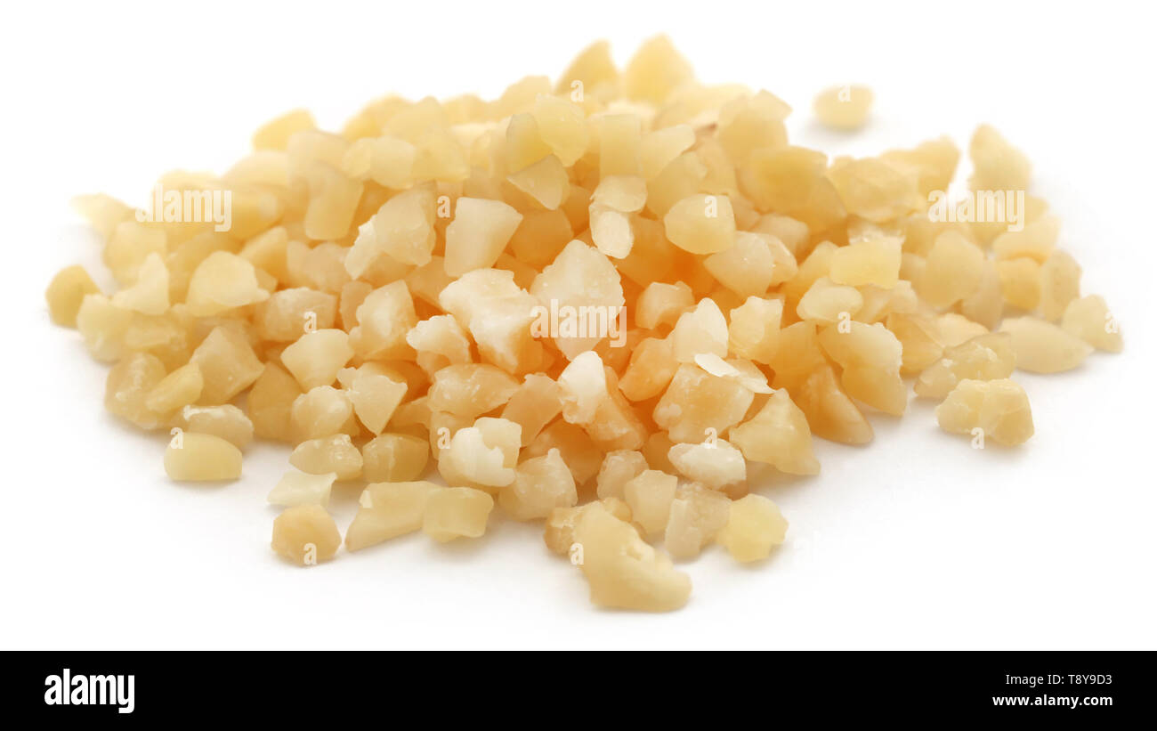 Small pieces of chopped almonds over white background Stock Photo - Alamy
