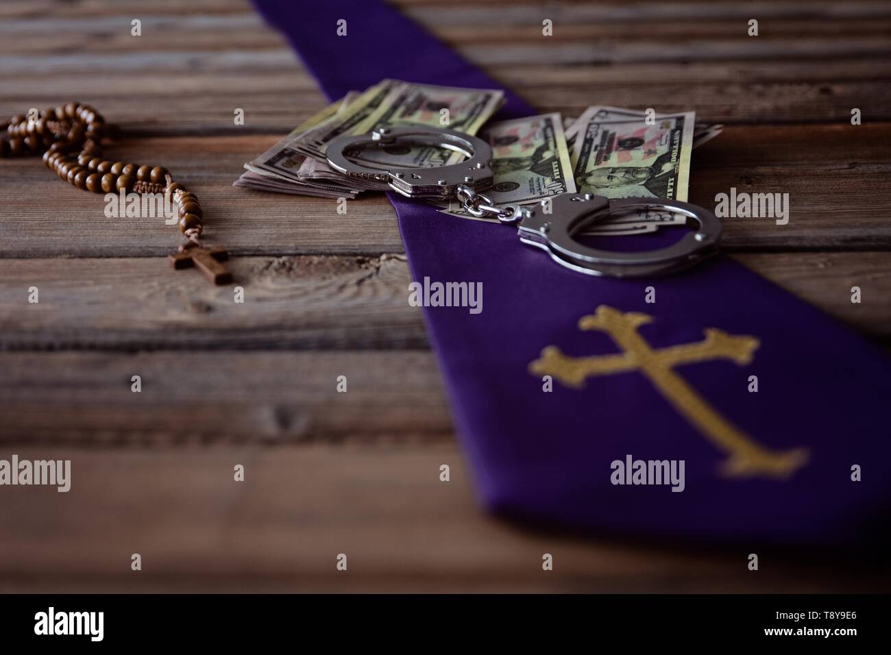 Banknotes and catholic church symbols. Church and money Stock Photo - Alamy