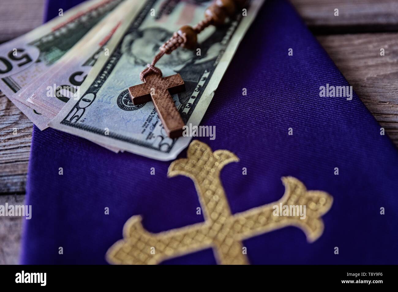 Wooden rosary and catholic church symbols and money. Church and money ...