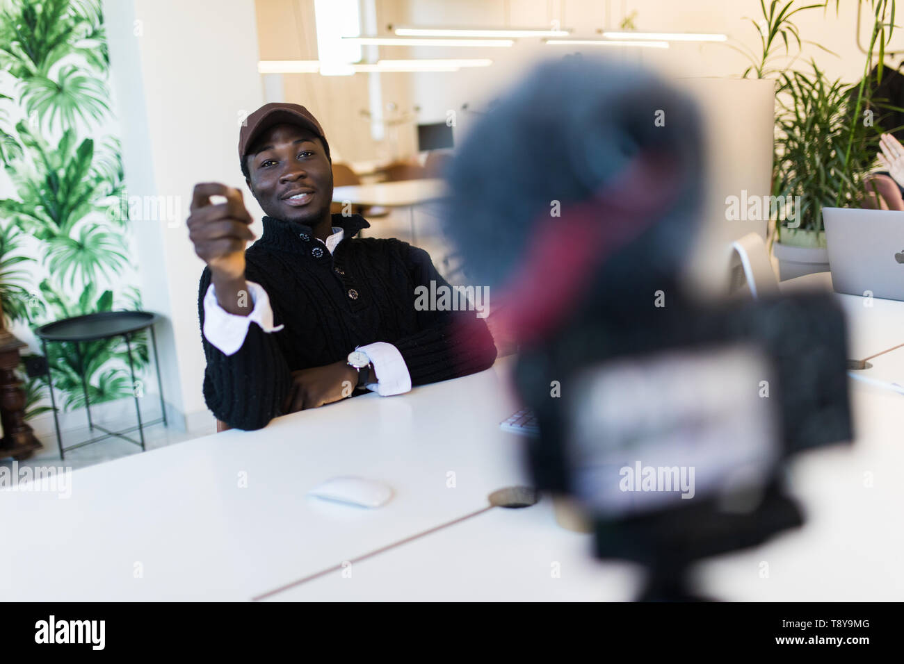 Young african man speaker talking on digital camera recording vlog ...