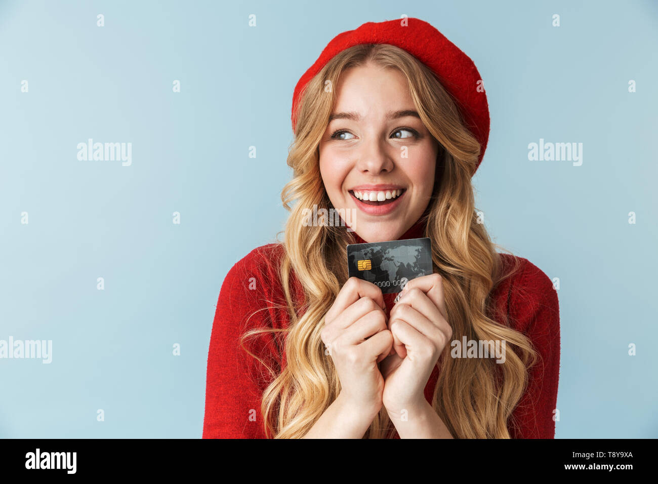 Photo of happy blond woman 20s wearing red beret holding credit card ...