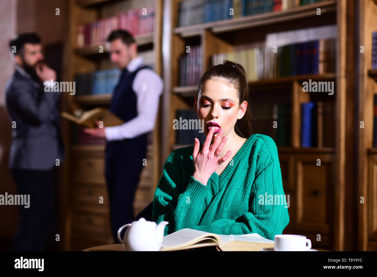 reading book and study poetry. woman in library read book at teapot ...