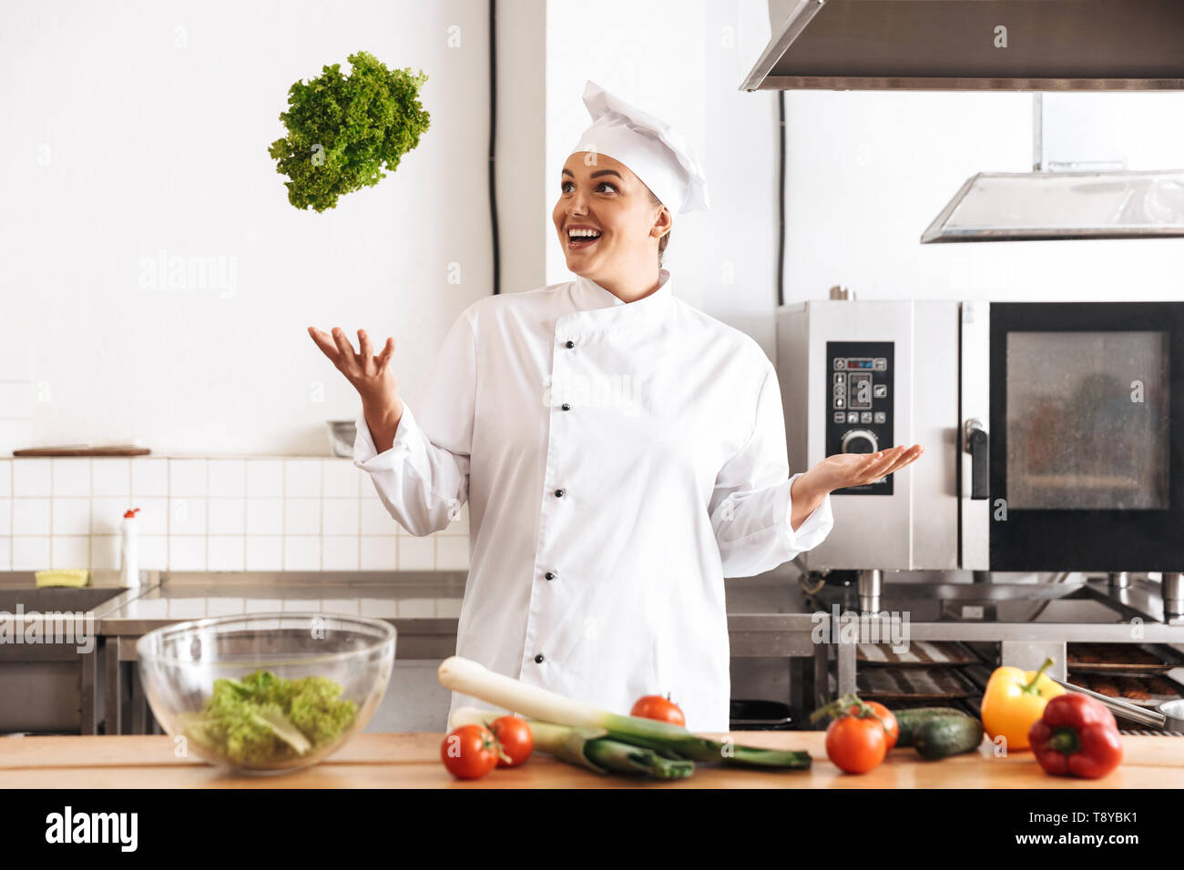 Photo of european woman chef wearing white uniform cooking meal with ...