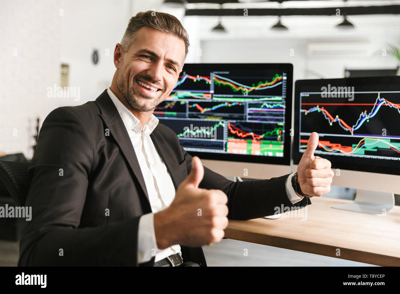 Image of happy businessman 30s wearing suit working in office on ...