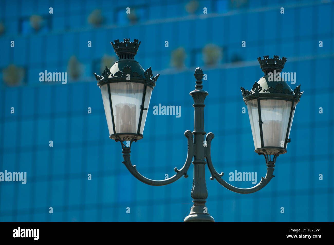 Lamp post on glass facade. Street lamp on sunny day. Street lighting of ...