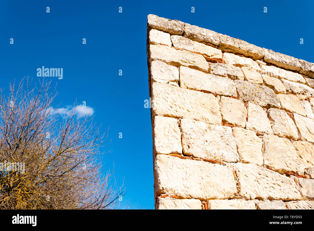 Old ancient white stone wall of Medieval cave city-fortress Chufut-Kale ...