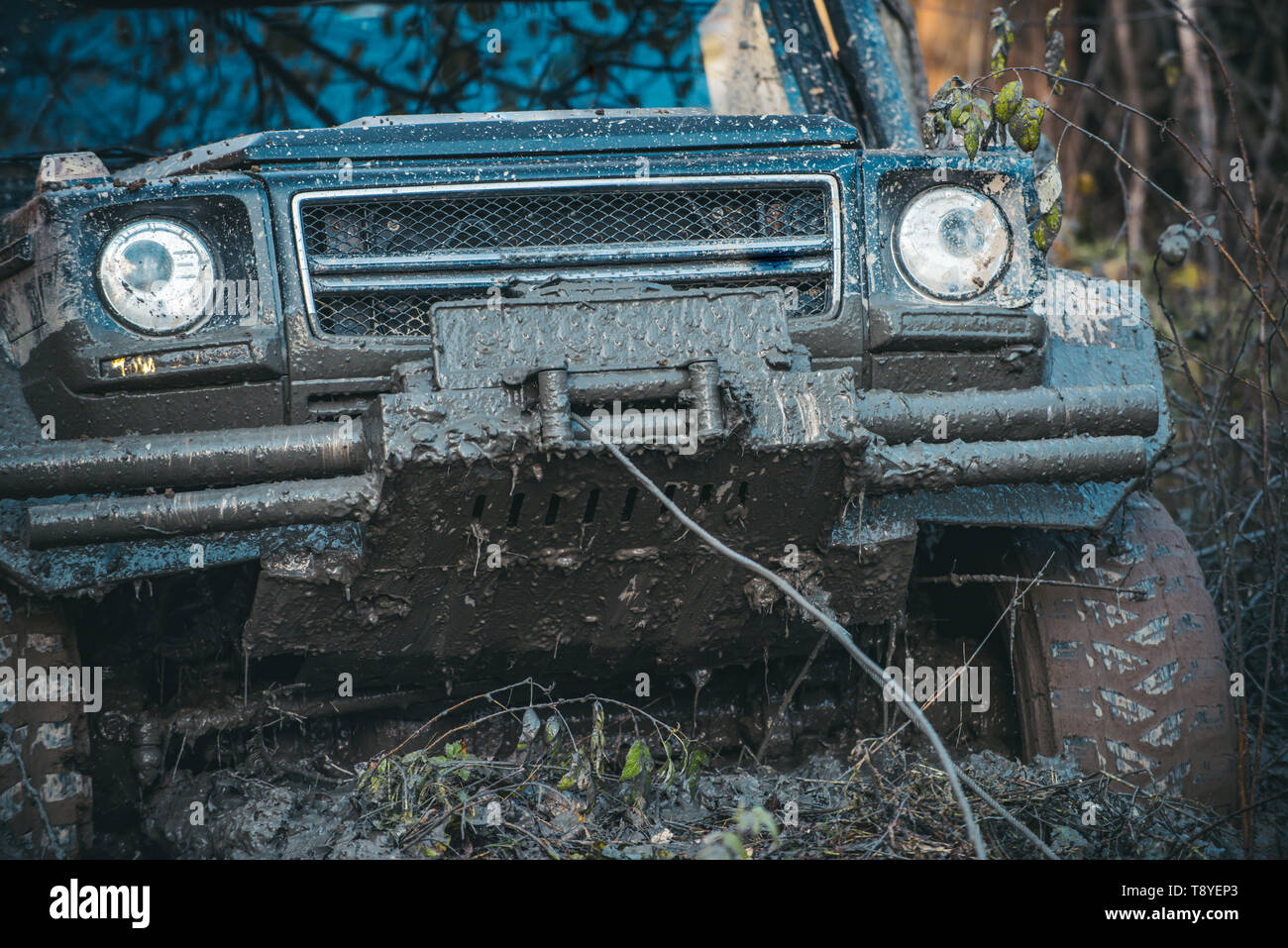 Extreme entertainment concept. Dirty offroad car stuck in deep rut ...