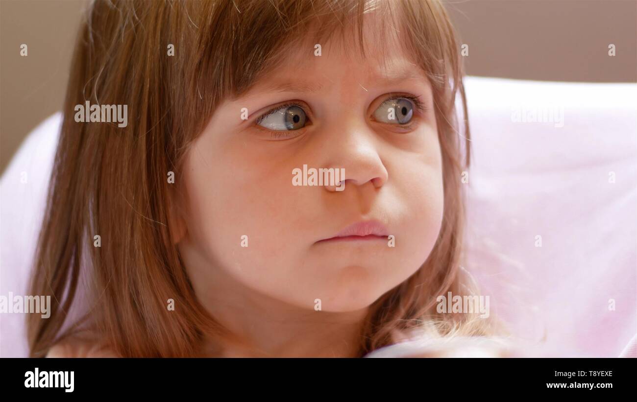 Little beautiful girl, baby infante, Caucasian. looks with his big blue ...