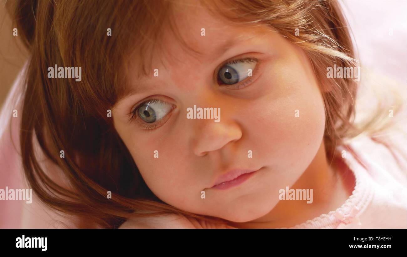 Little beautiful girl, baby infante, Caucasian. looks with his big blue ...