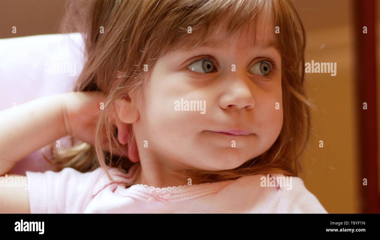 Little beautiful girl, baby infante, Caucasian. looks with his big blue ...