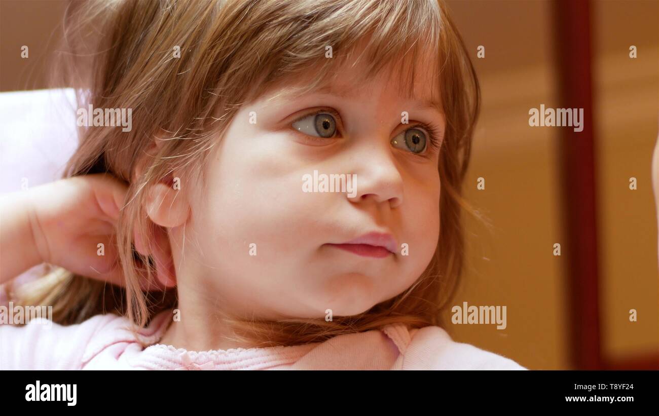 Little beautiful girl, baby infante, Caucasian. looks with his big blue ...