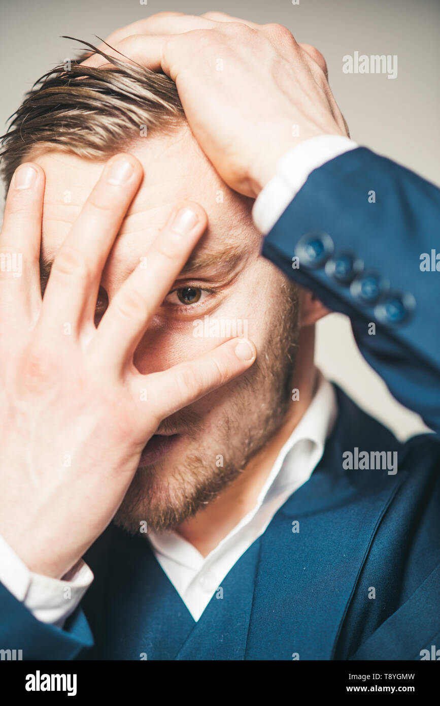 Painful memories. Guy hiding out of reality. Man serious unhappy hiding ...