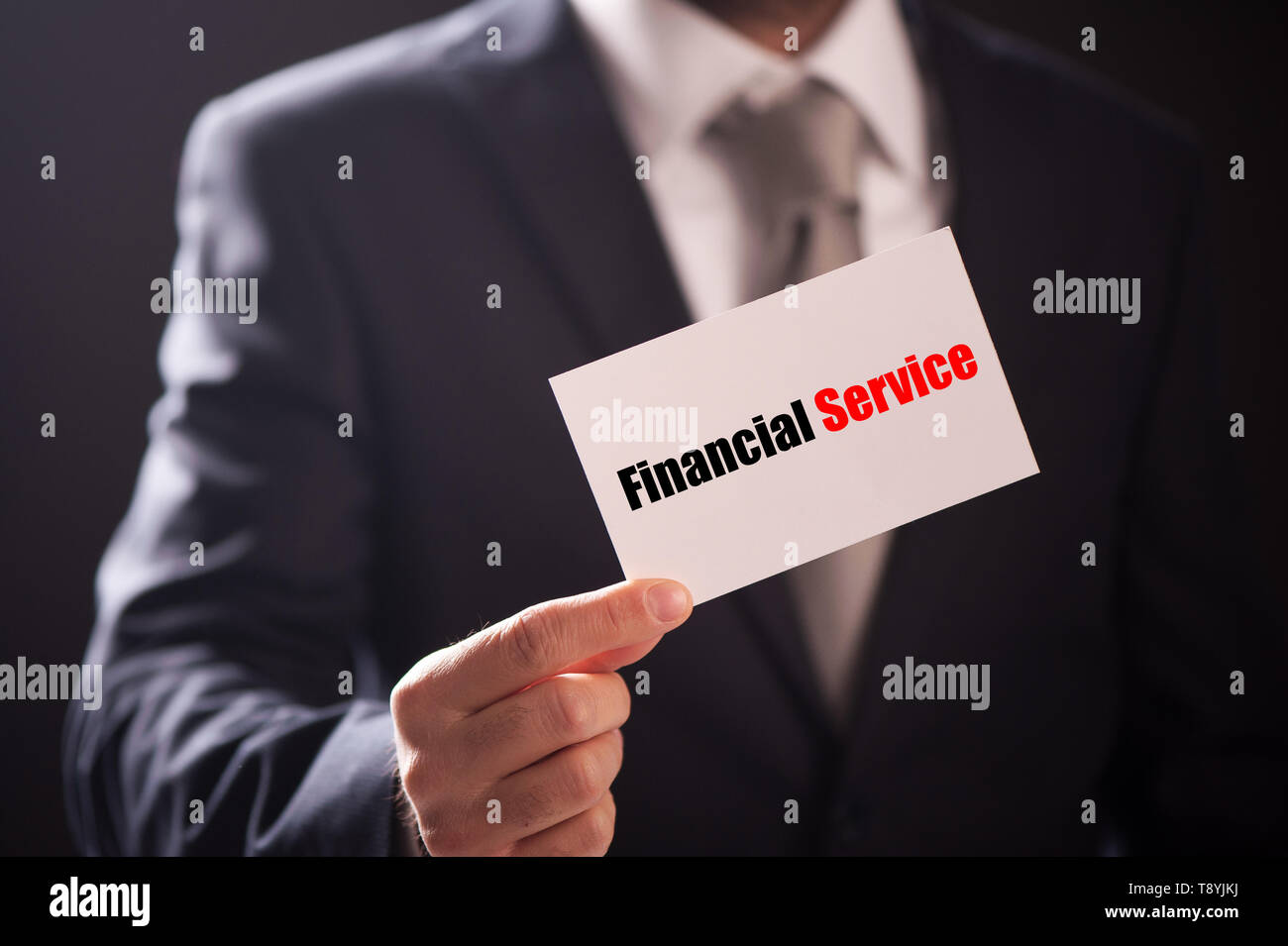 Businessman showing his visiting card - Financial service word on it ...
