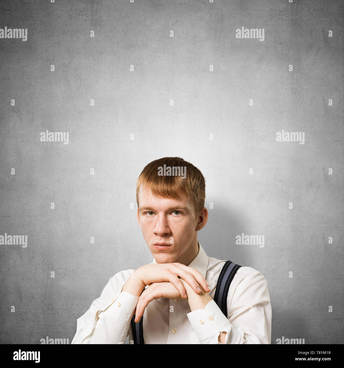 Sad teenager with arms touching his chin Stock Photo - Alamy