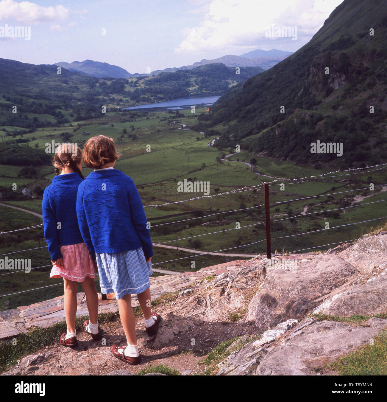 1960s, historical, two young girls, sisters wearing matching blue ... 1960s, historical, two young girls, sisters wearing matching blue ...