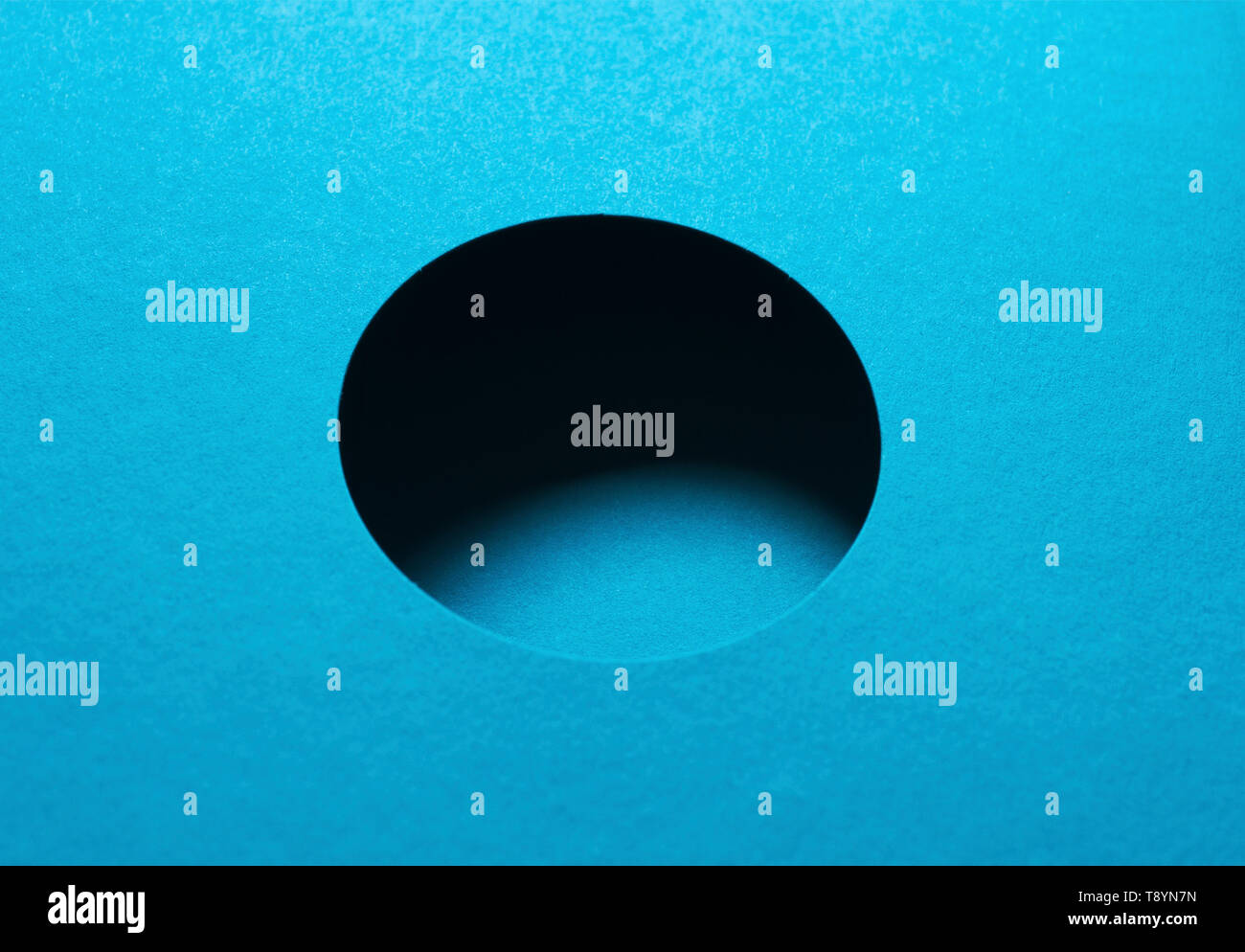 circular shaped hole with shadow on blue cardboard paper Stock Photo ...