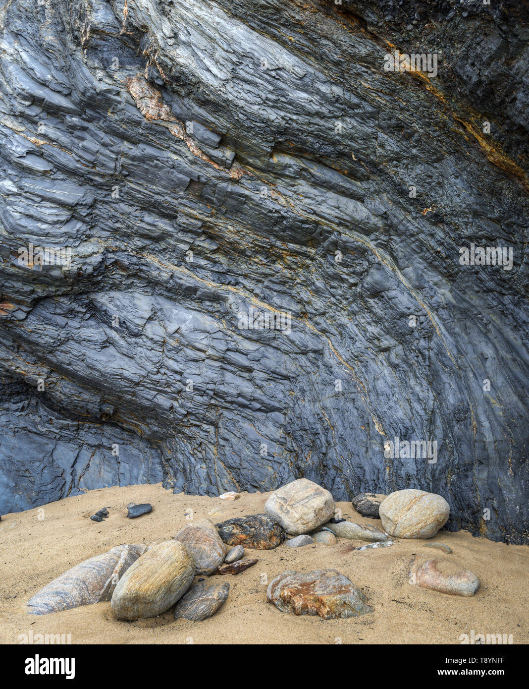 Rocky structure showing thin stratified layers and a pronounced curved ...