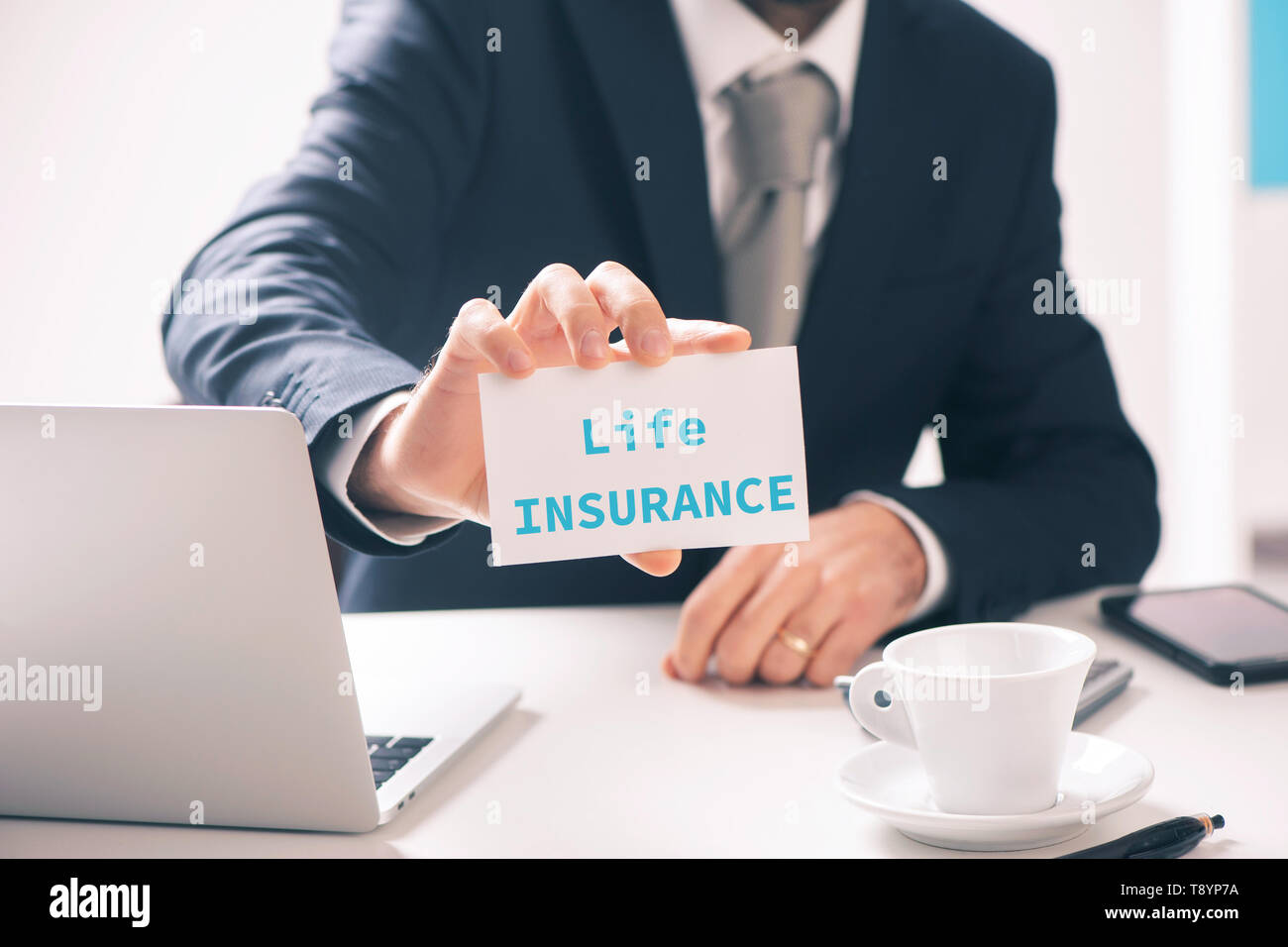 Insurance, message on white card and hold by a business man close up ...