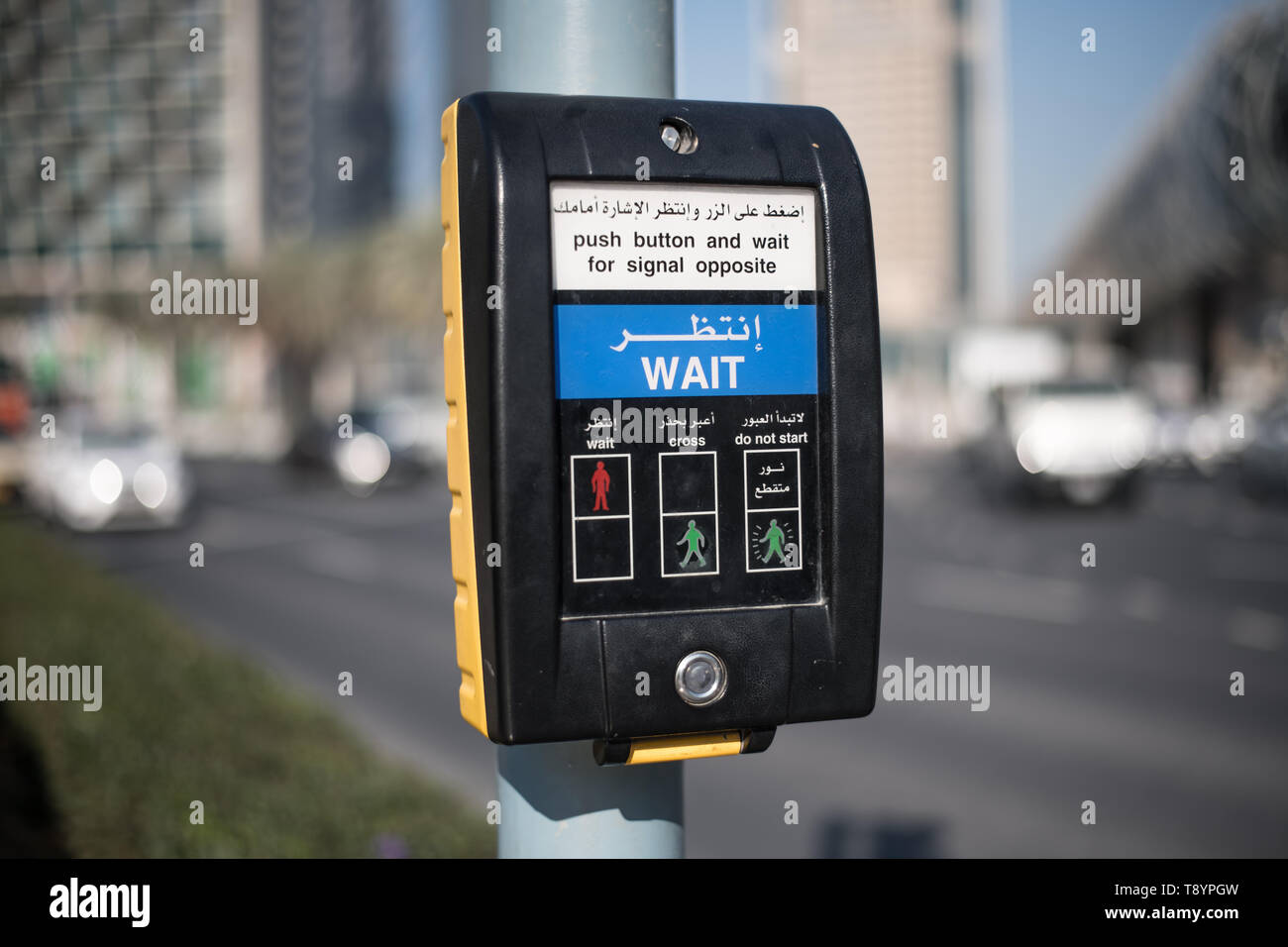 A device with a traffic light control button for pedestrians shows a ...