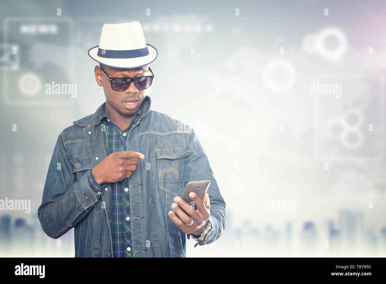 Young american african guy with cell phone. Handsome man. Device ...