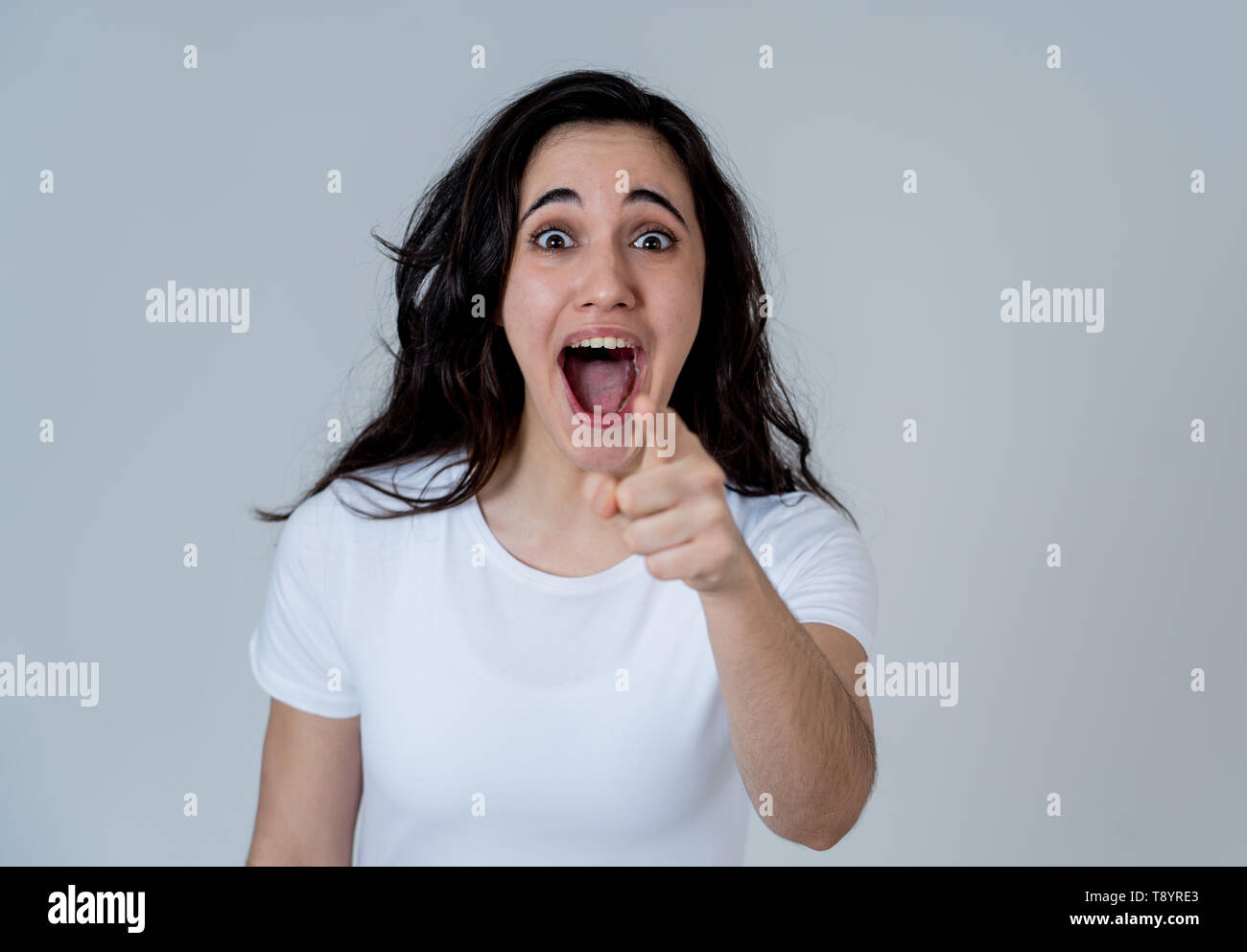 Excited latin teenager girl surprised and shocked feeling amazed by ...