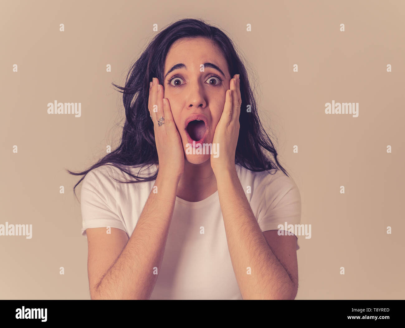 Excited latin teenager girl surprised and shocked feeling amazed by ...