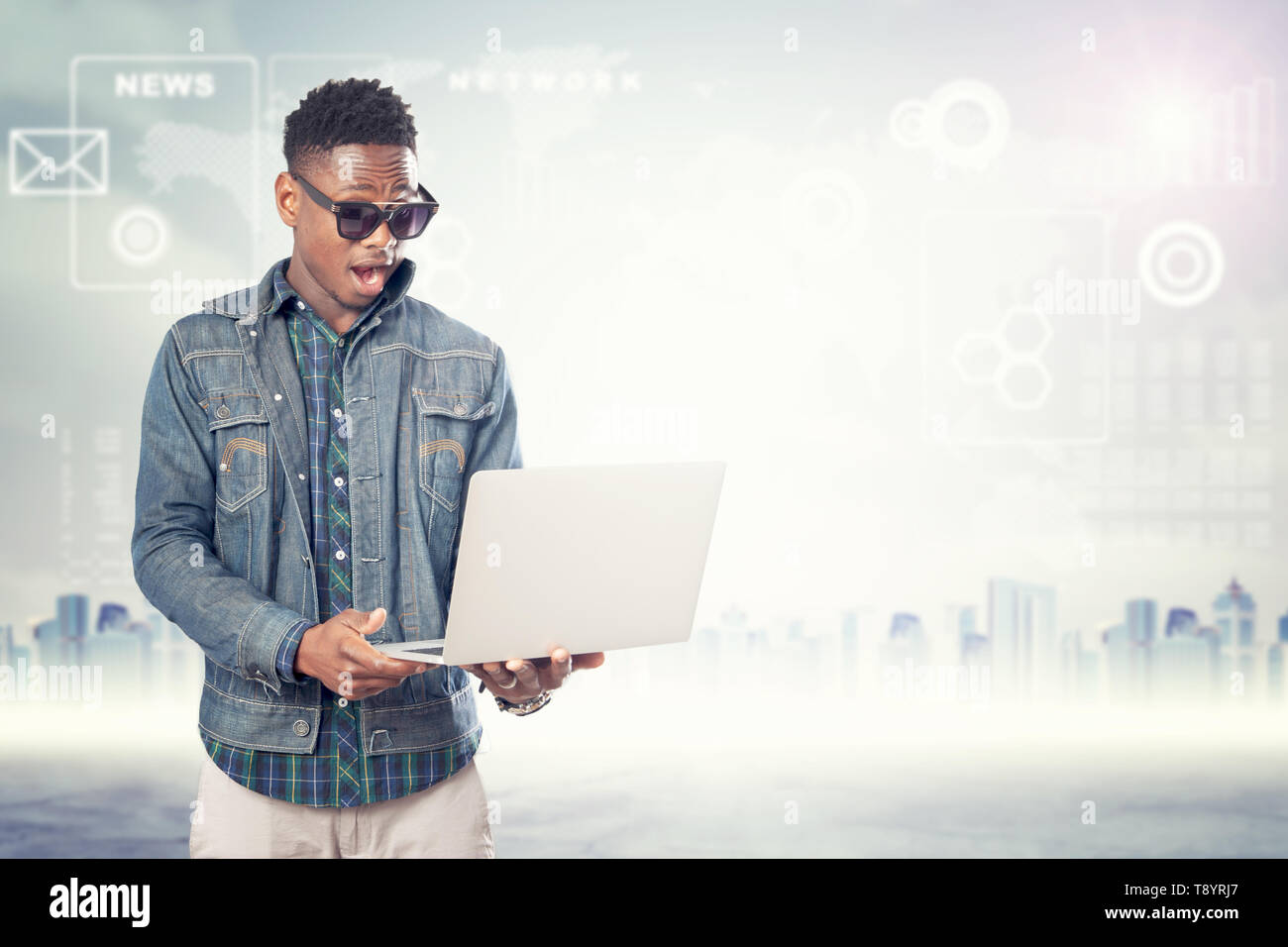 Portrait happy successful young man with laptop computer. Connecting ...