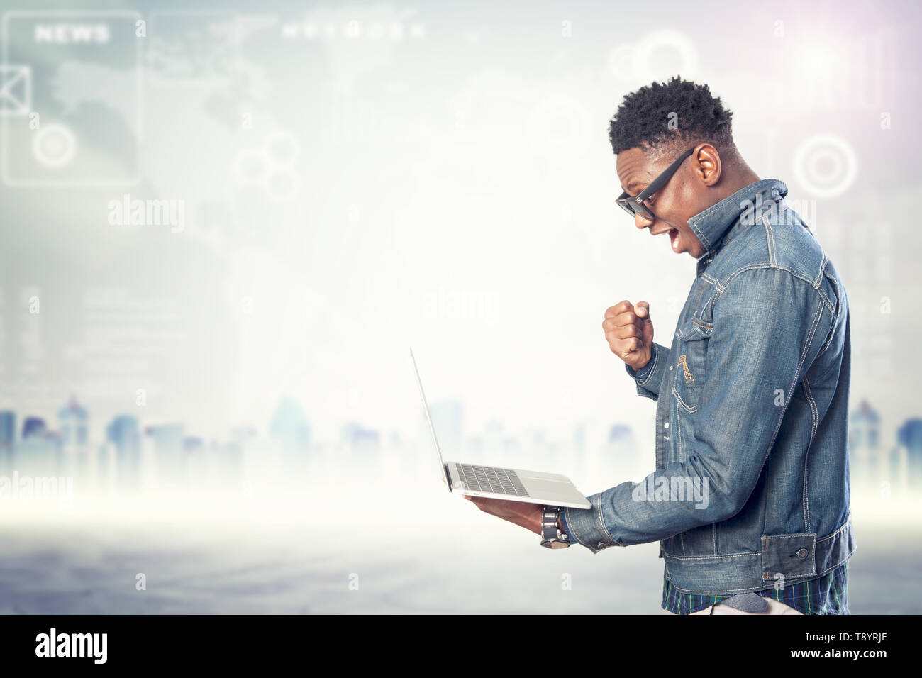 Portrait happy successful young man with laptop computer. Connecting ...