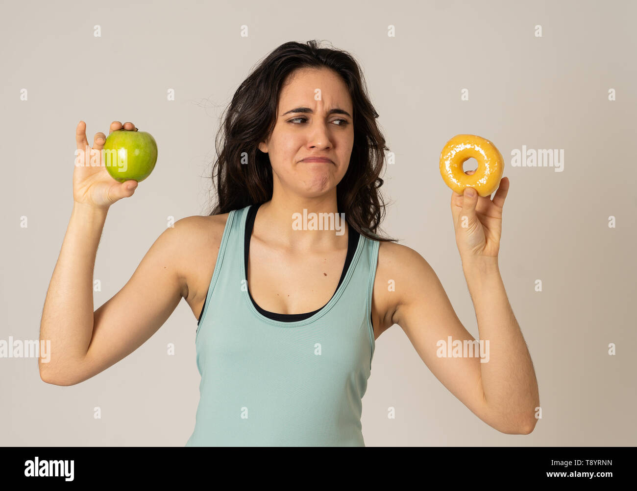 Young woman tempted junk food hi-res stock photography and images - Alamy