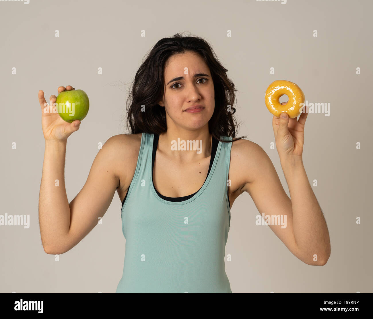 Young woman tempted junk food hi-res stock photography and images - Alamy