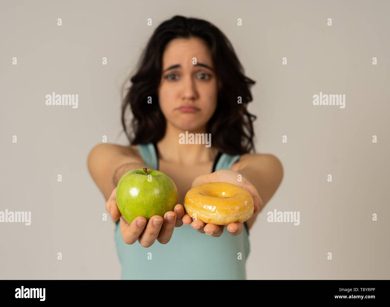 Young woman tempted junk food hi-res stock photography and images - Alamy