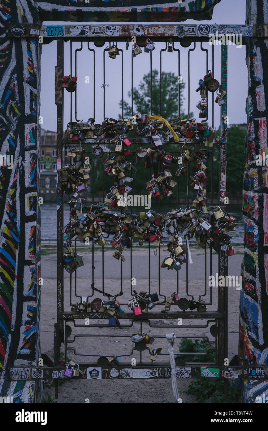Barred gate with many locks taken in Berlin Stock Photo - Alamy