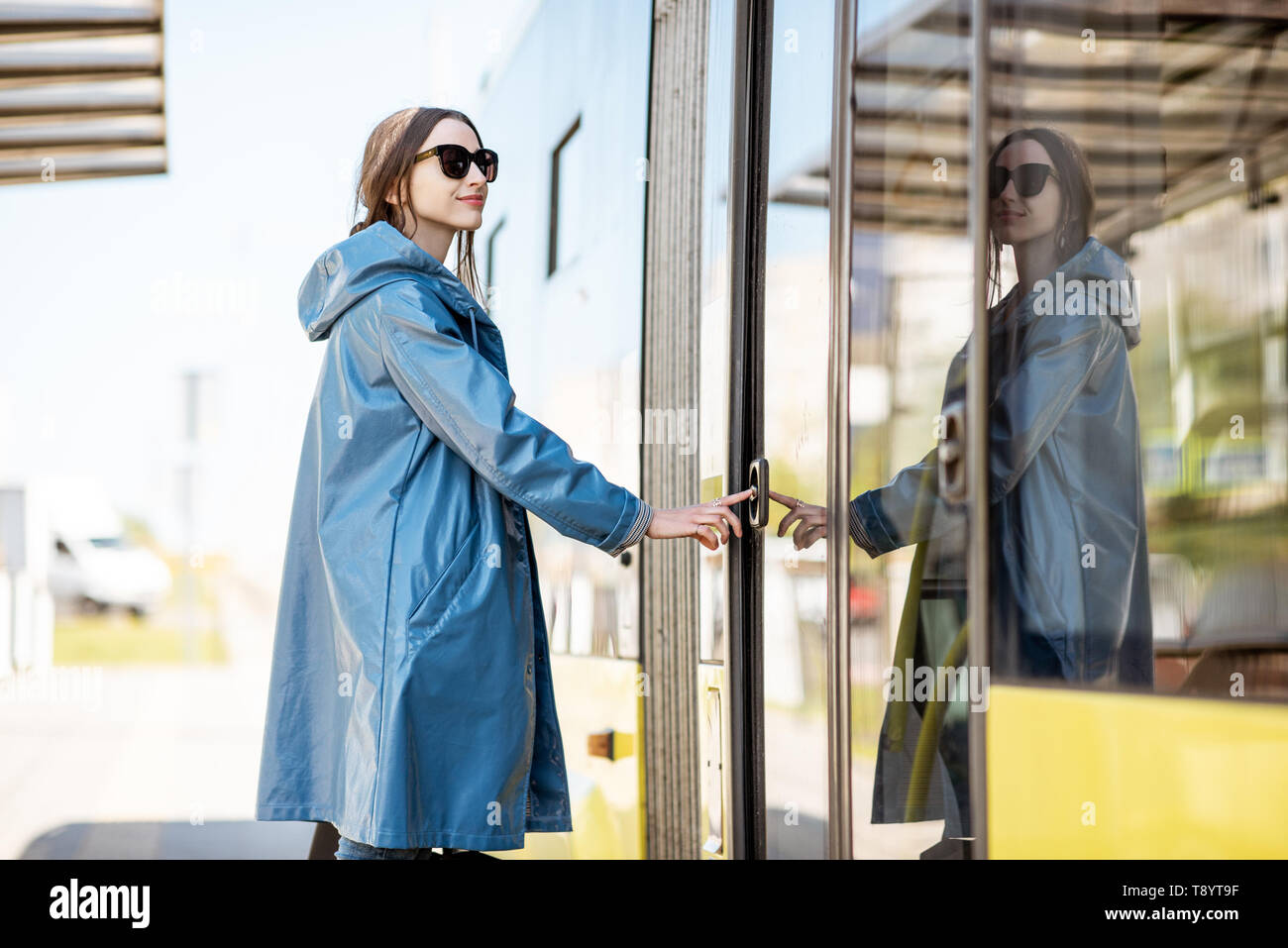 Woman entering the door of the modern tram at the station Stock Photo ...