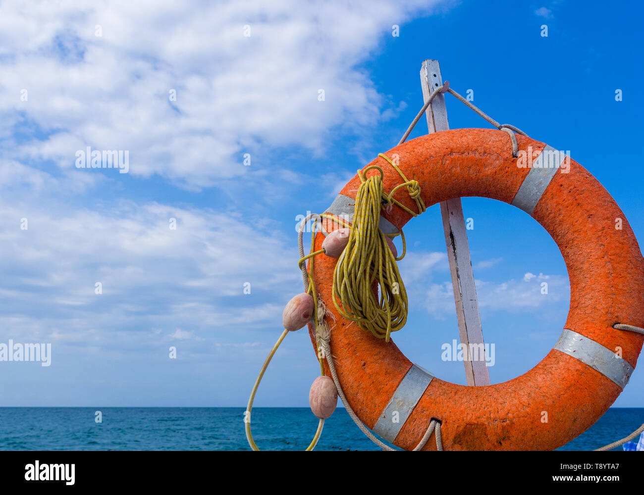 Orange emergency lifebuoy on a pebbly sea beach Stock Photo - Alamy
