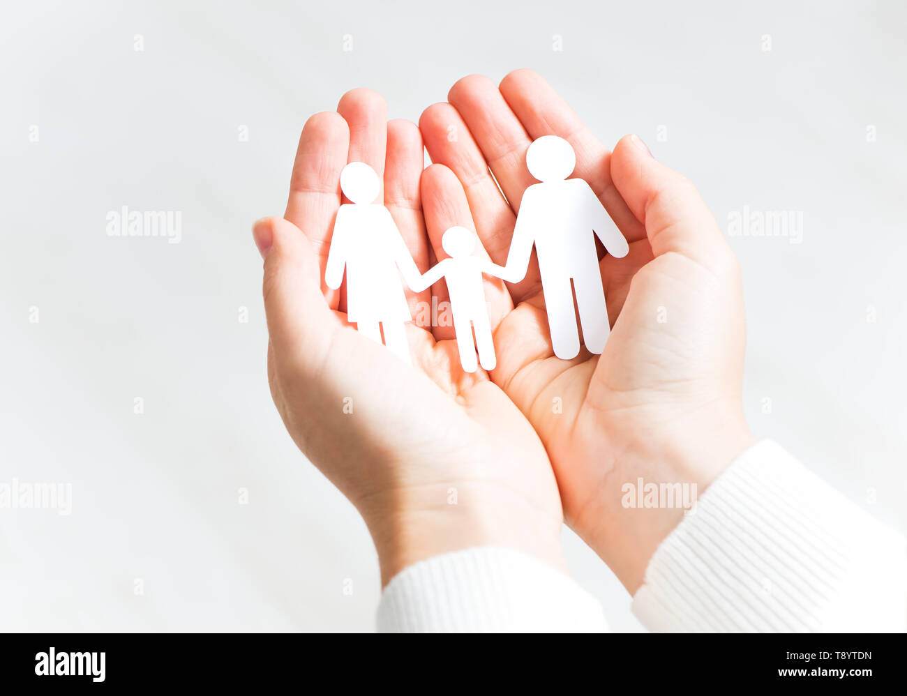 Paper cut family in two hands Stock Photo - Alamy