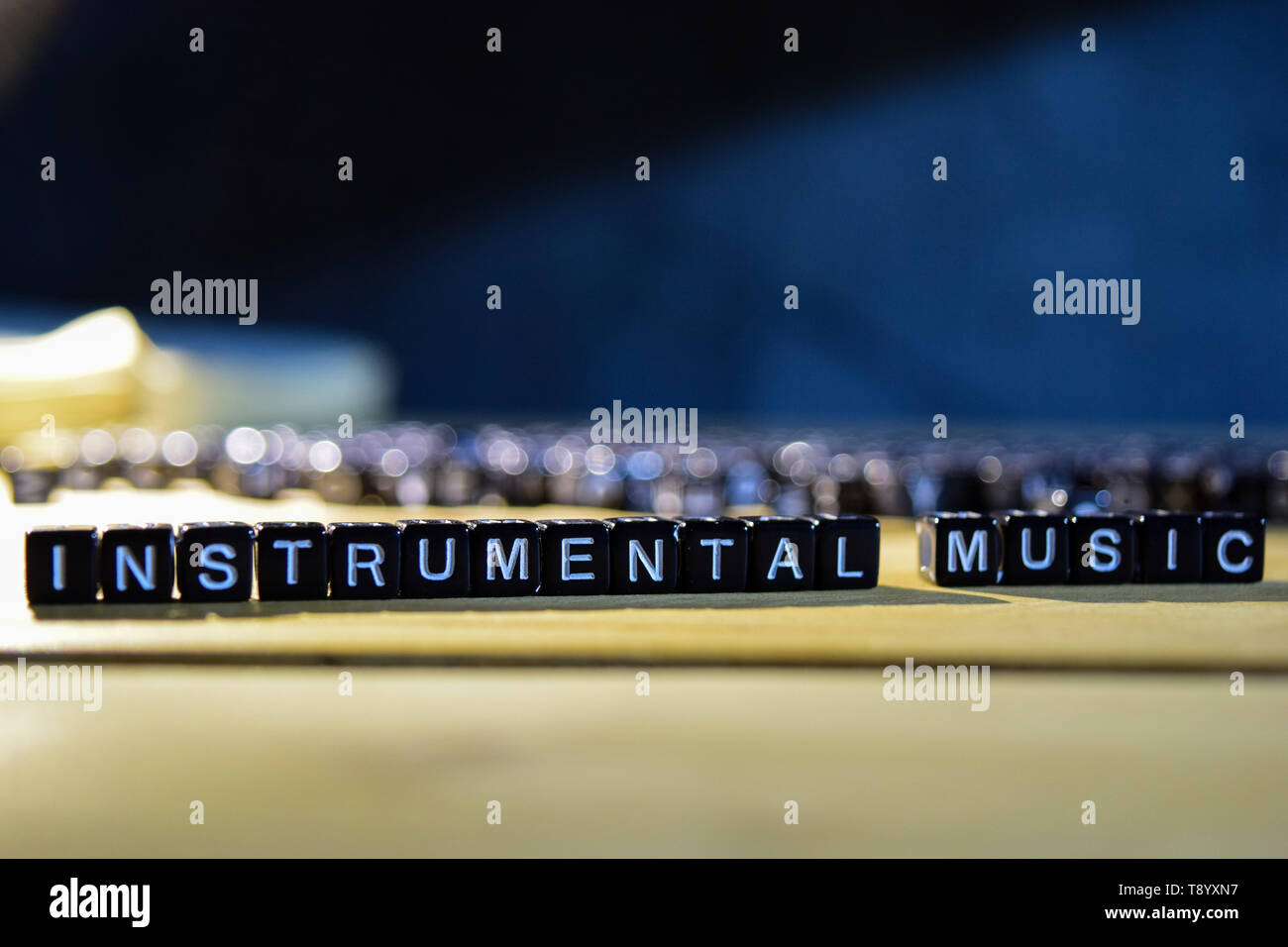 INSTRUMENTAL MUSIC concept wooden blocks on the table. With personal ...