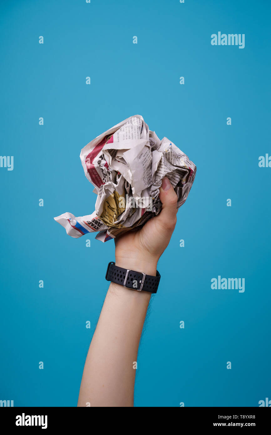 hand with crumpled newspaper Stock Photo - Alamy