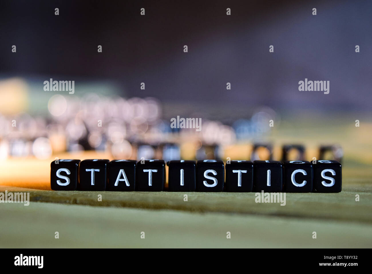 STATISTICS concept wooden blocks on the table. With personal ...