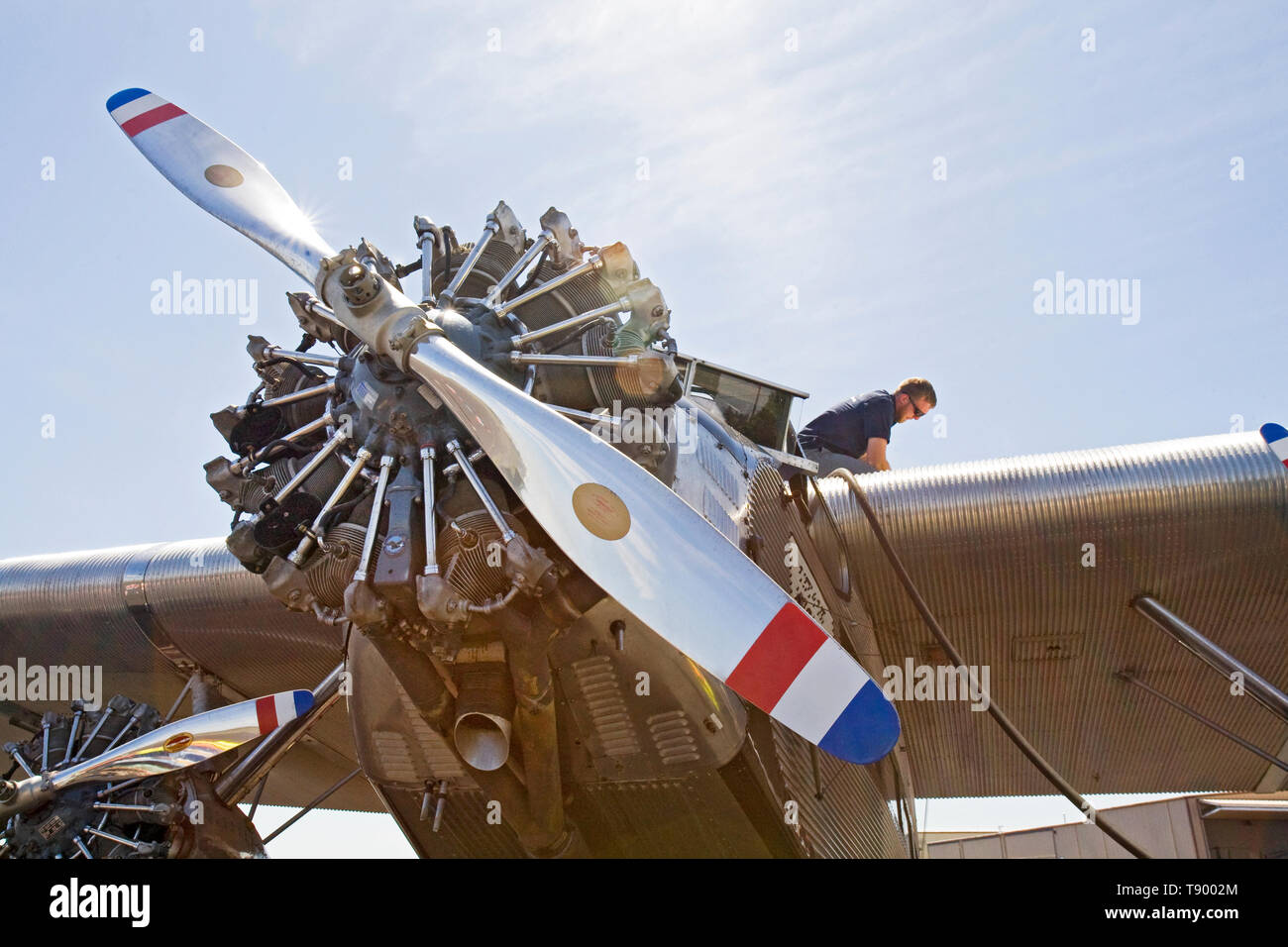A pilot refuels a 1928 Ford Tri-Motor 5-AT-B airplane, powered by three ...