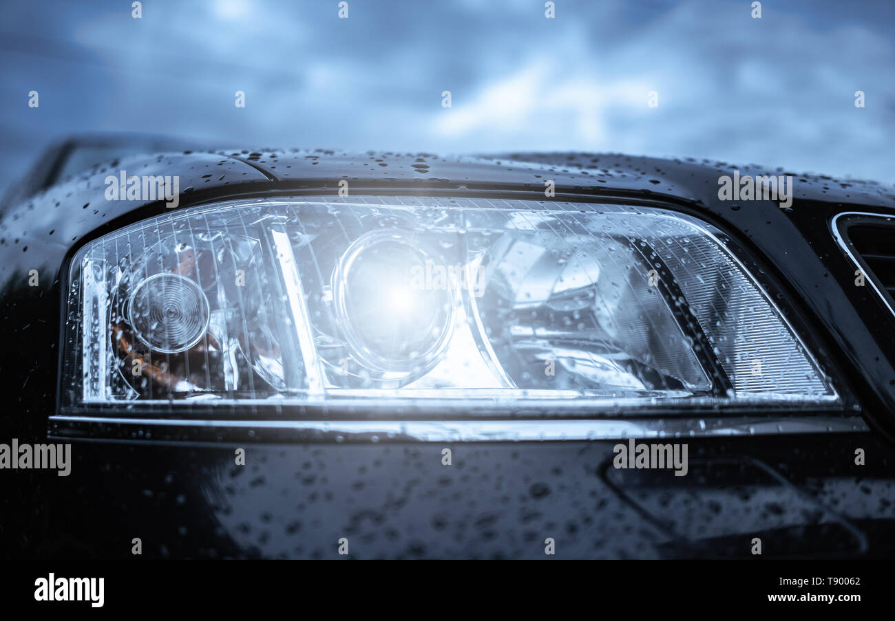 Wet car headlight Stock Photo - Alamy