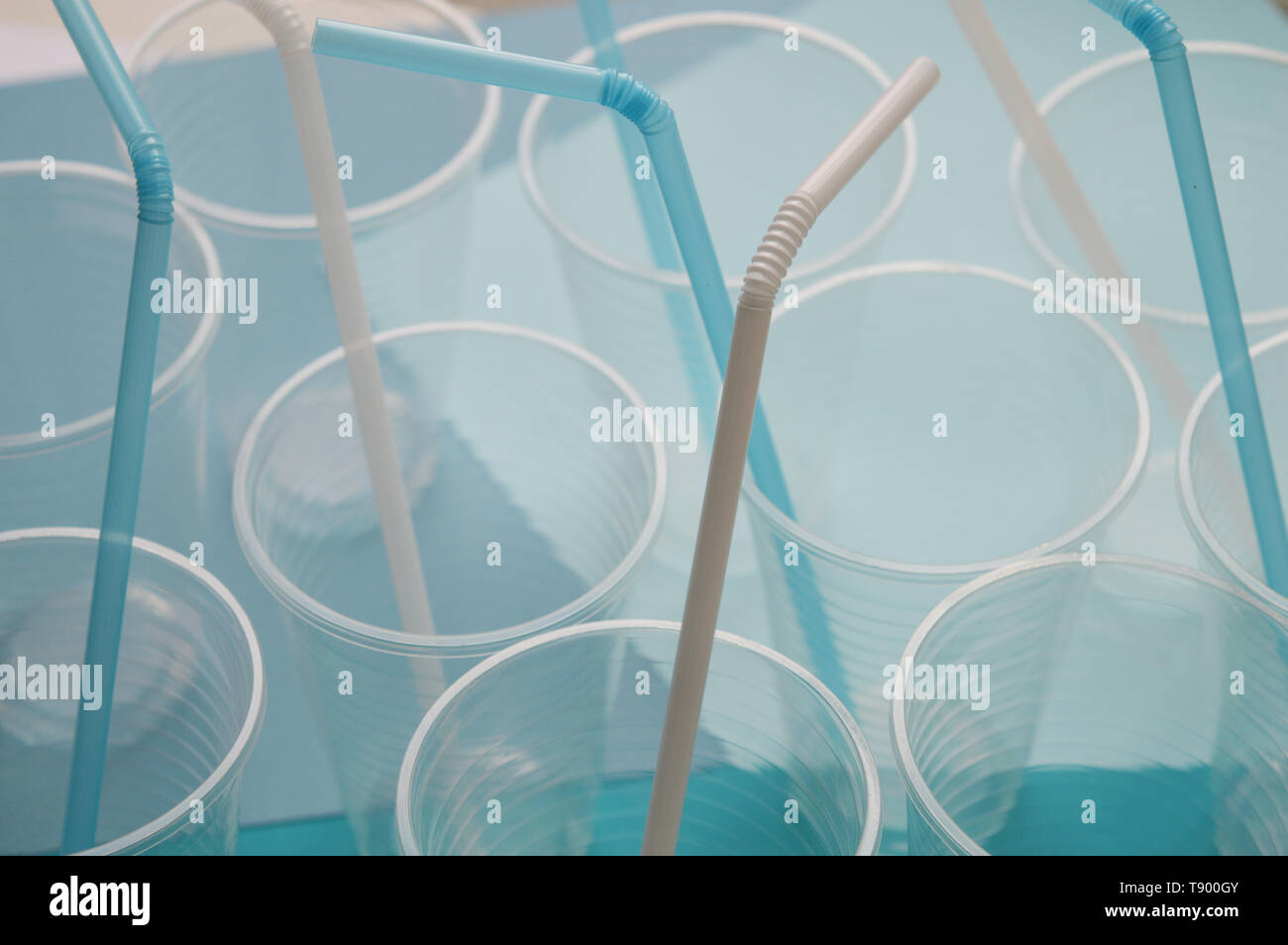 Plastic cups with white and blue straw tubules. Concept of plastic ...