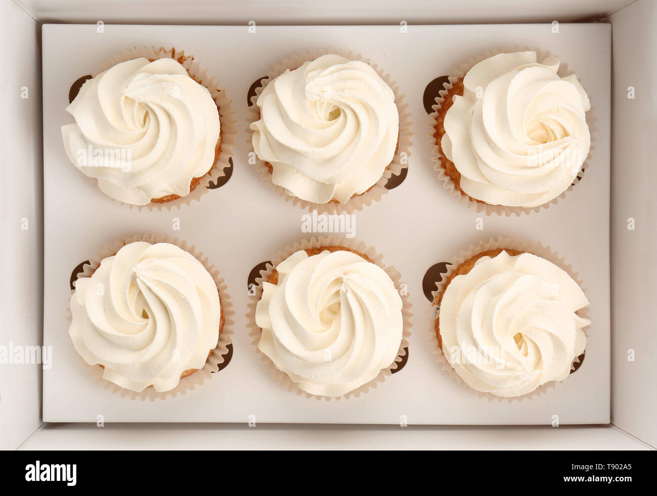 Box with delicious cupcakes, top view Stock Photo - Alamy