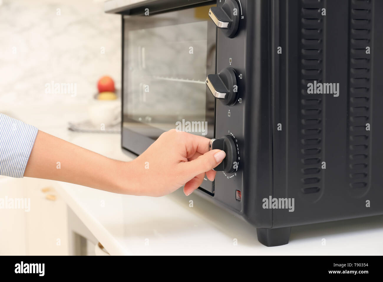 Hand adjusting stove knob hi-res stock photography and images - Alamy