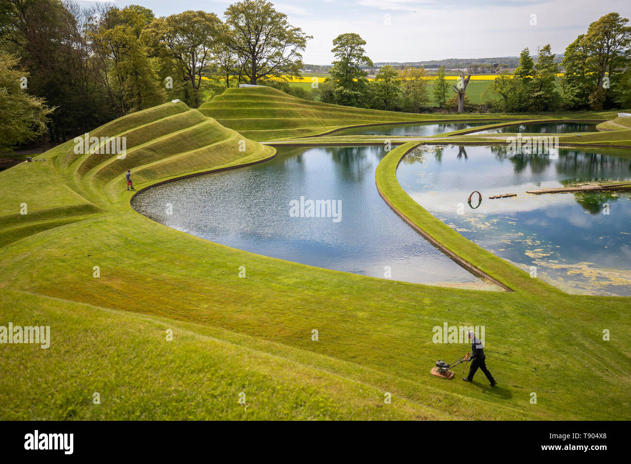 Gardeners mow grass on cells life landforms created hi-res stock ...