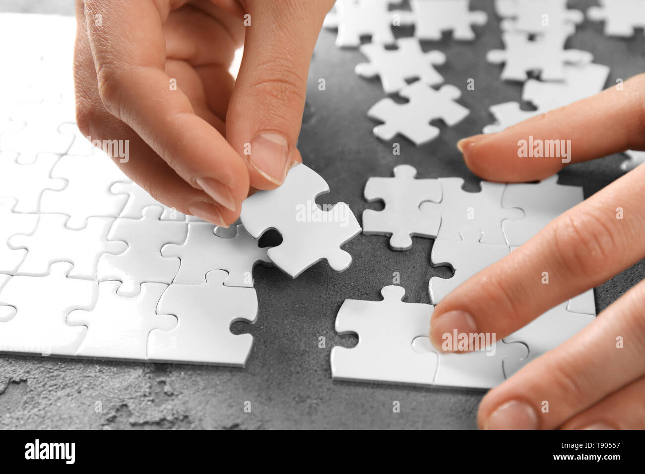 Woman doing jigsaw puzzle hi-res stock photography and images - Alamy
