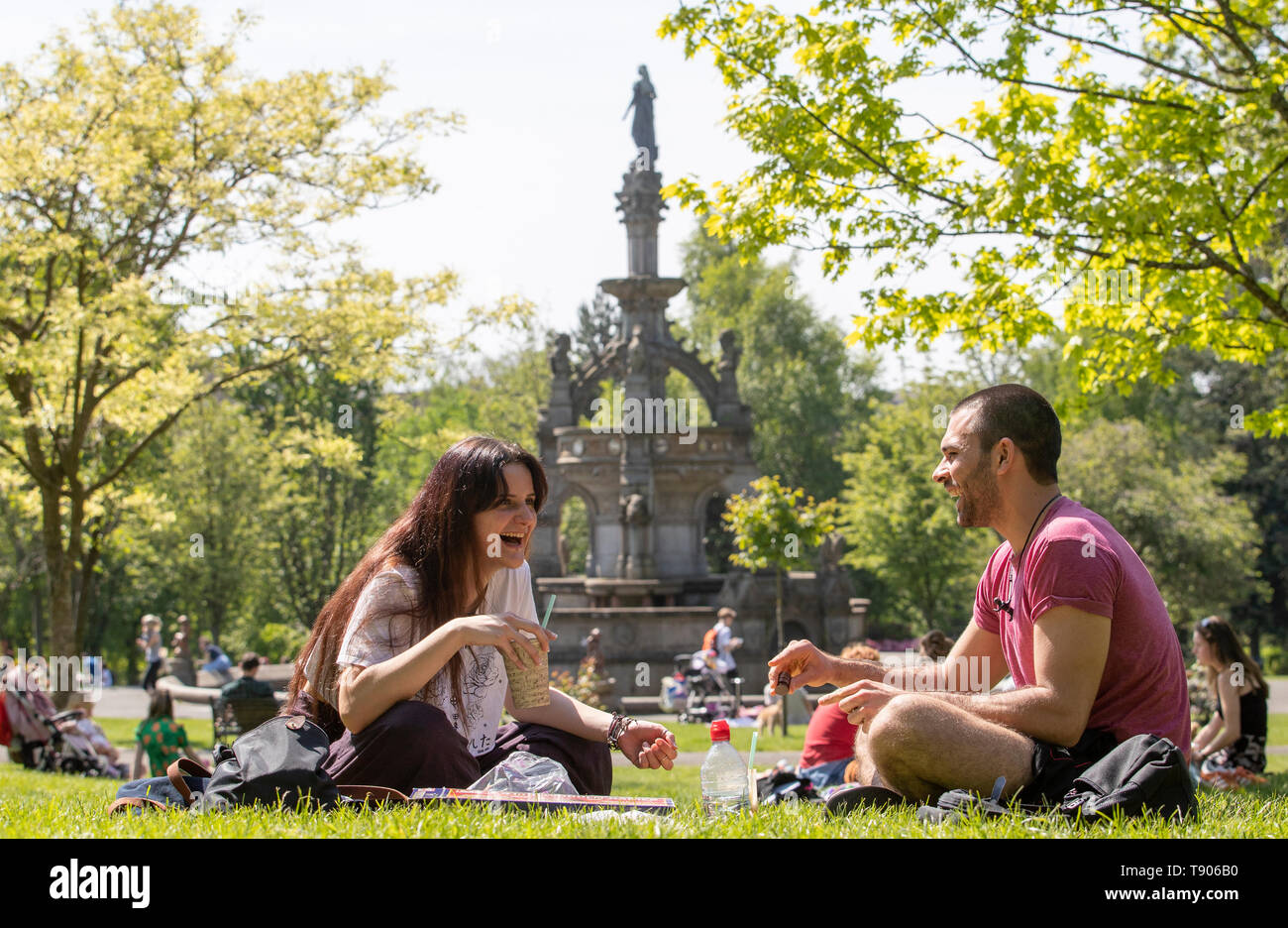 Students Iris Mandragouda (left) and Costas Spanachis enjoy the sunshine in Glasgow's ...
