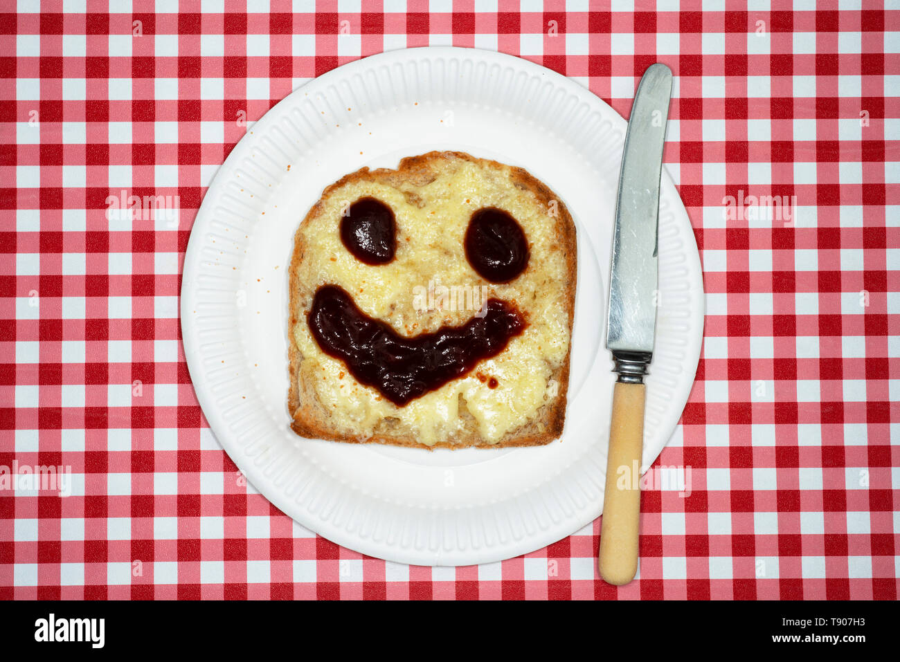 Cheese on toast with tomato ketchup smily face Stock Photo - Alamy