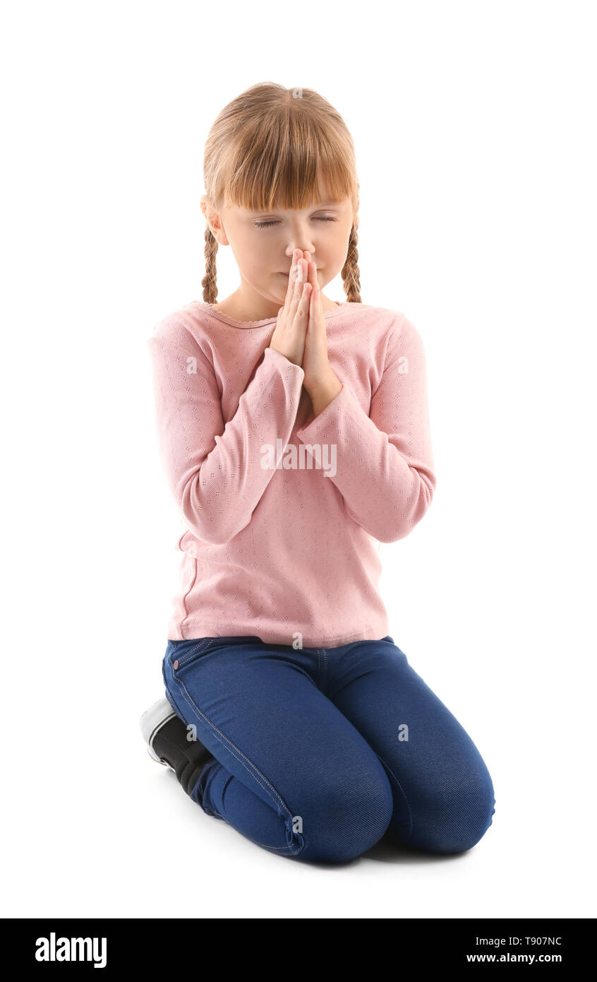 Little girl praying on white background Stock Photo - Alamy
