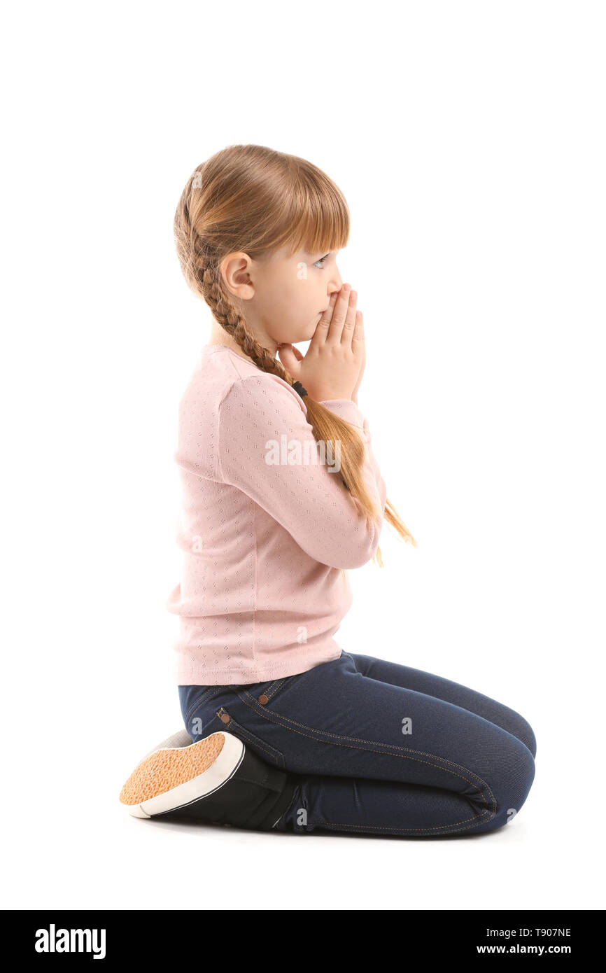 Little girl praying on white background Stock Photo - Alamy